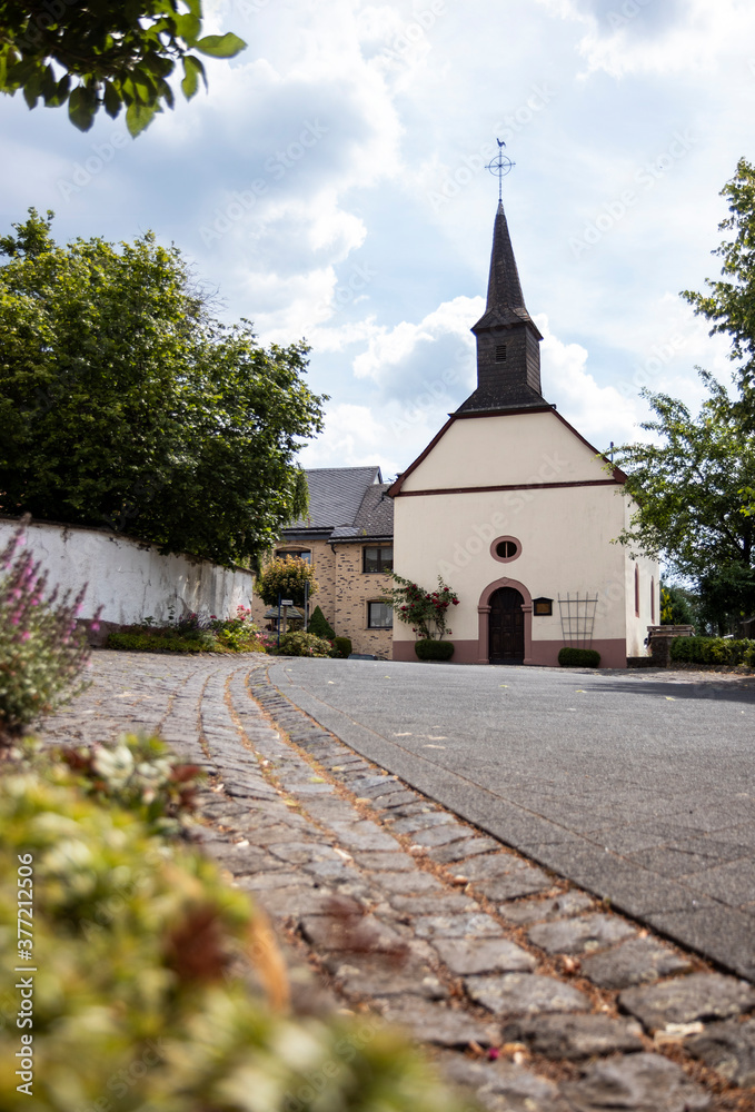 Little church in small German town photographed from a low angle ...
