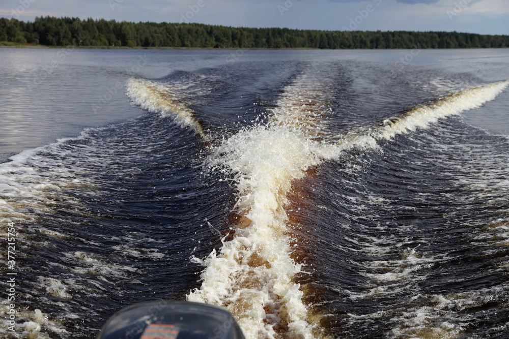 Back view from speed gliding motor boat on splash water and transom ...