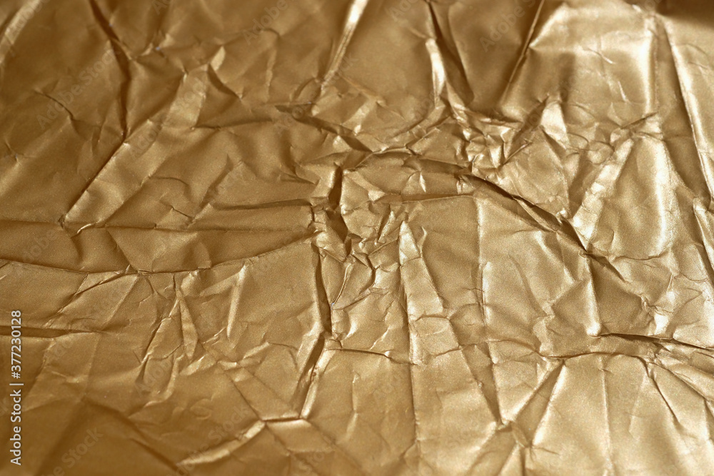 Crumpled gold-colored paper. Background golden from paper top view ...