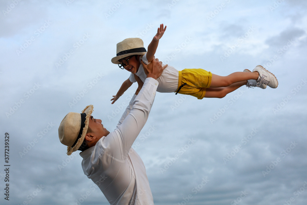 Holiday concept, Father lift his son up and swing on sky Stock Photo ...