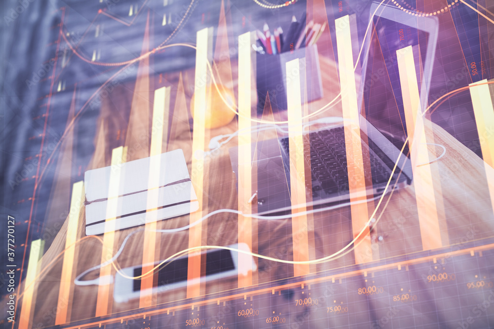 Stock market graph on background with desk and personal computer ...