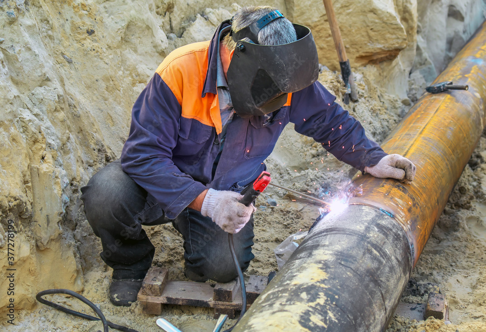 Welding of the pipeline. Process of creation of welding connection by ...
