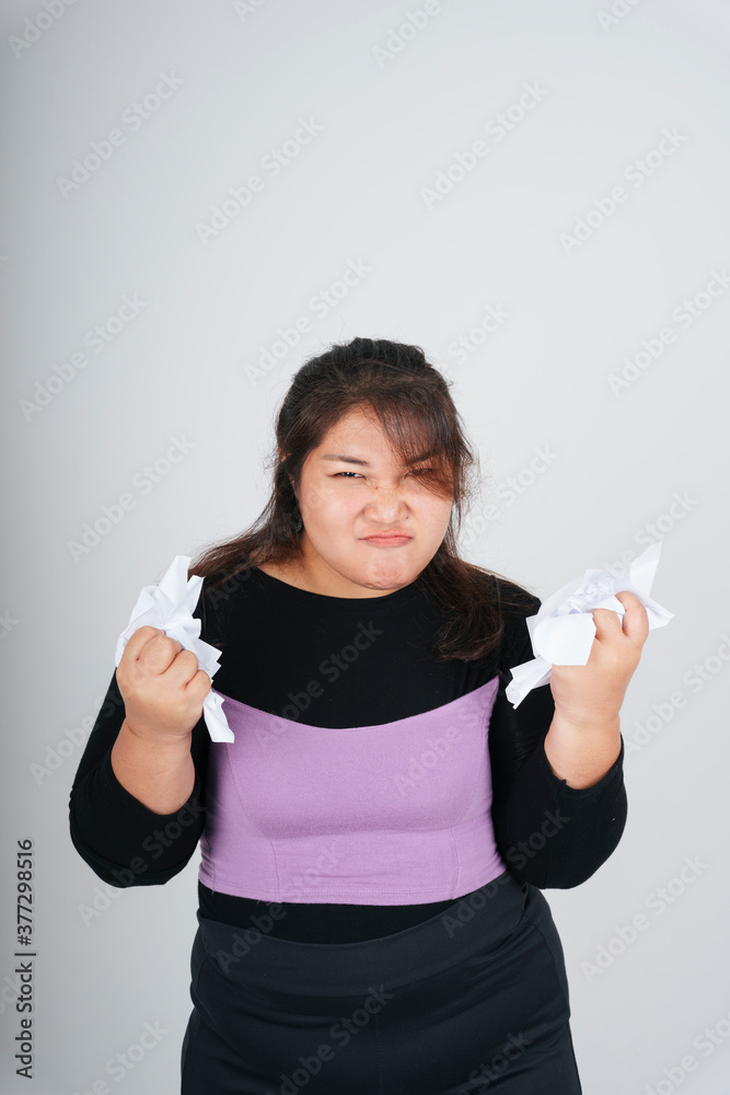 Angry chubby business woman torn up sheet paper with both hands. Stock ...