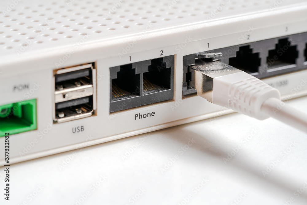 Internet cable connected to LAN port socket of router. Stock Photo ...