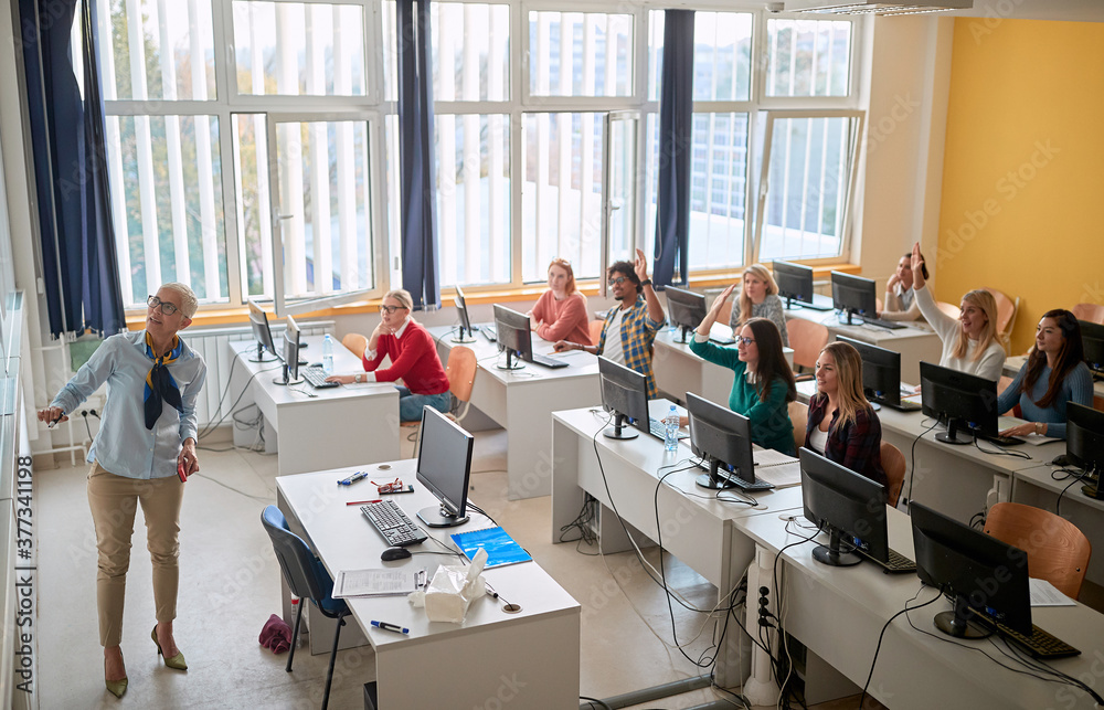 FEmale professor lecturing in the university computer classroom Stock ...