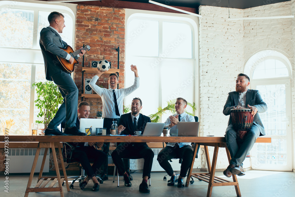 Singing, giving music concert, dancing. Happy carefree colleagues ...