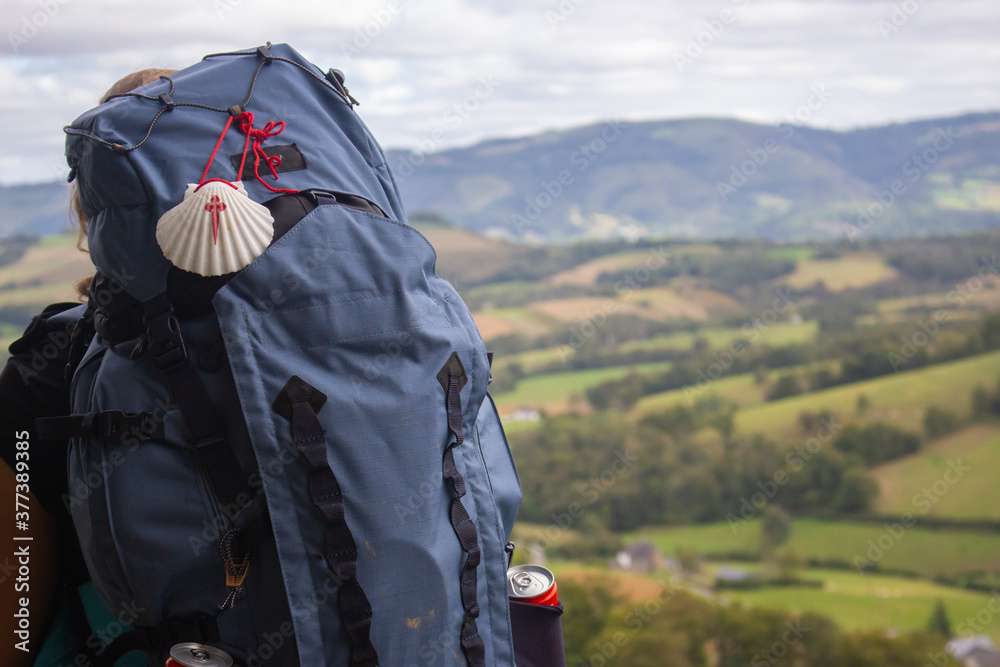Big backpack with pilgrim shell on mountain background. Pilgrimage ...