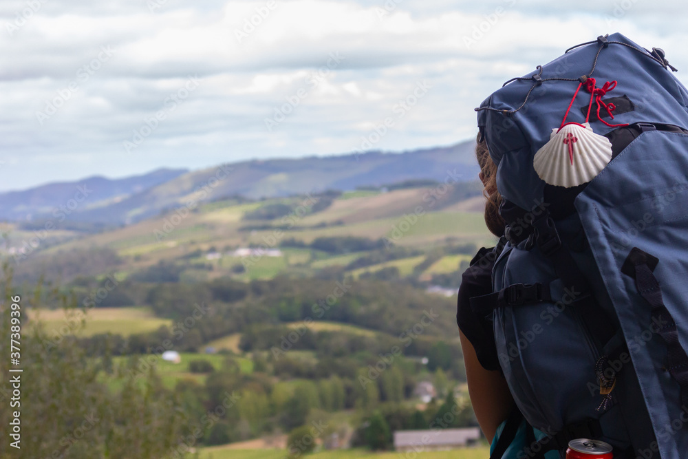 Big backpack with pilgrim shell on mountain background. Pilgrimage ...