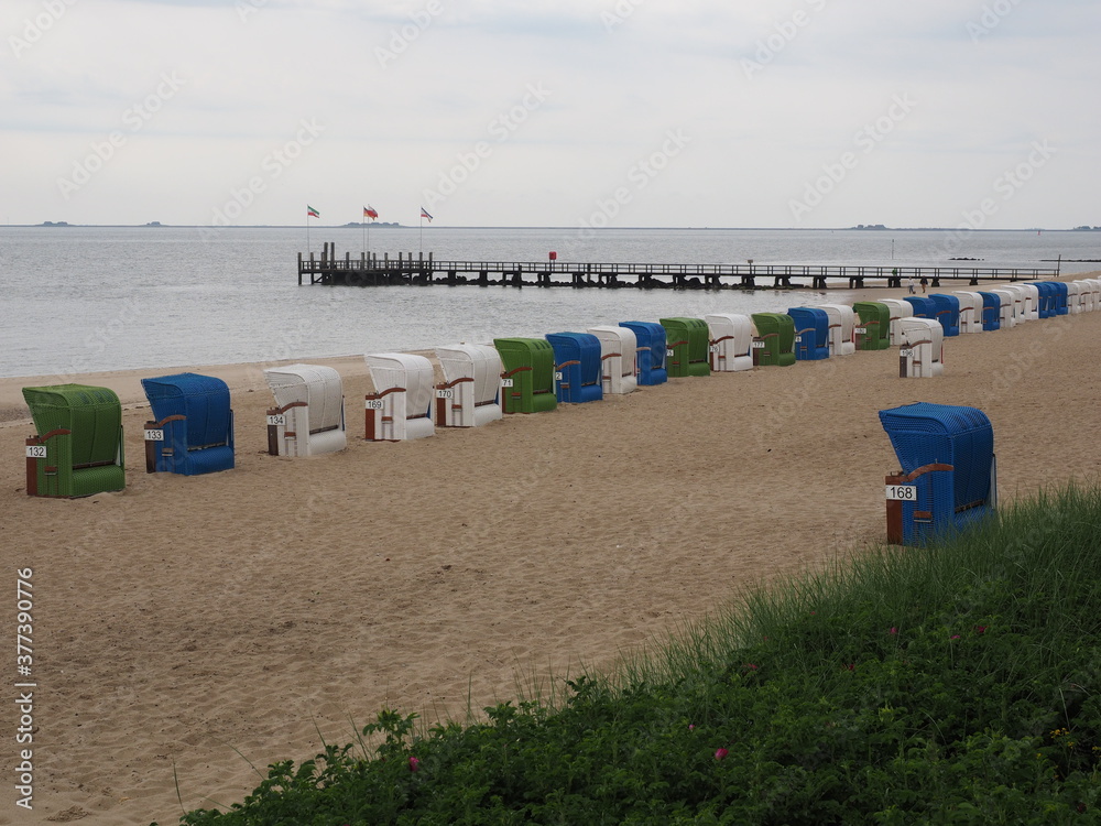 strandkoerbe am strand im sand Stock Photo | Adobe Stock