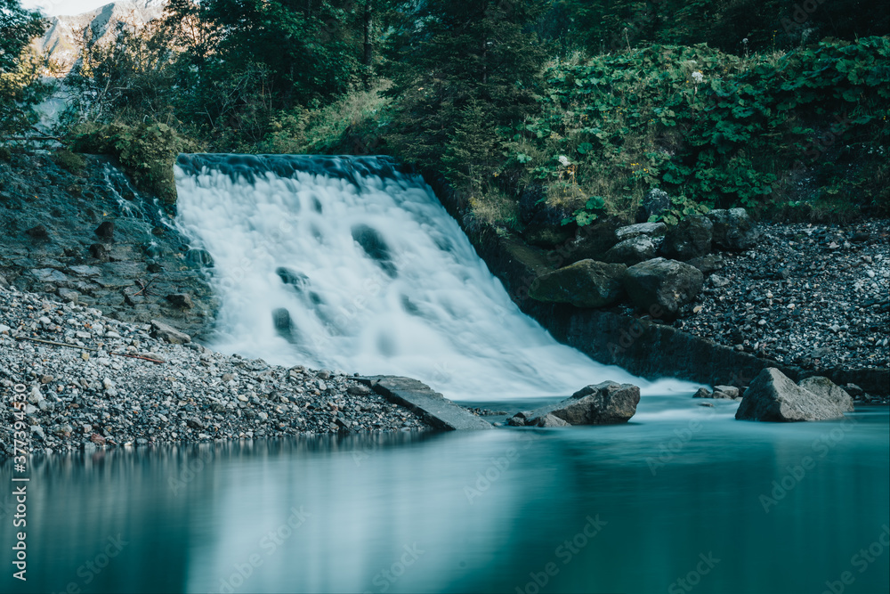 Cascadas de un río en medio de unas montañas Stock Photo | Adobe Stock