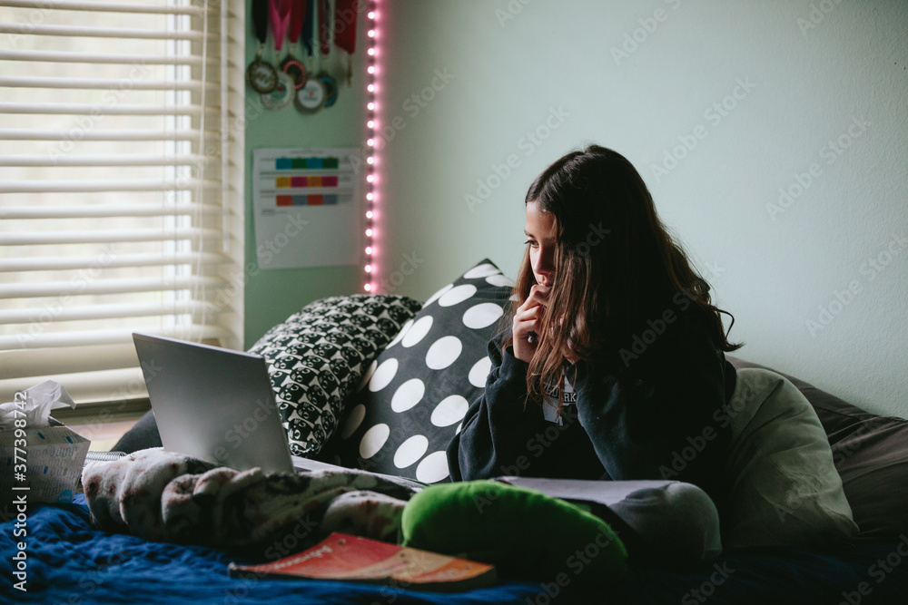 Tween girl attends a zoom meeting for class during quarantine Stock ...