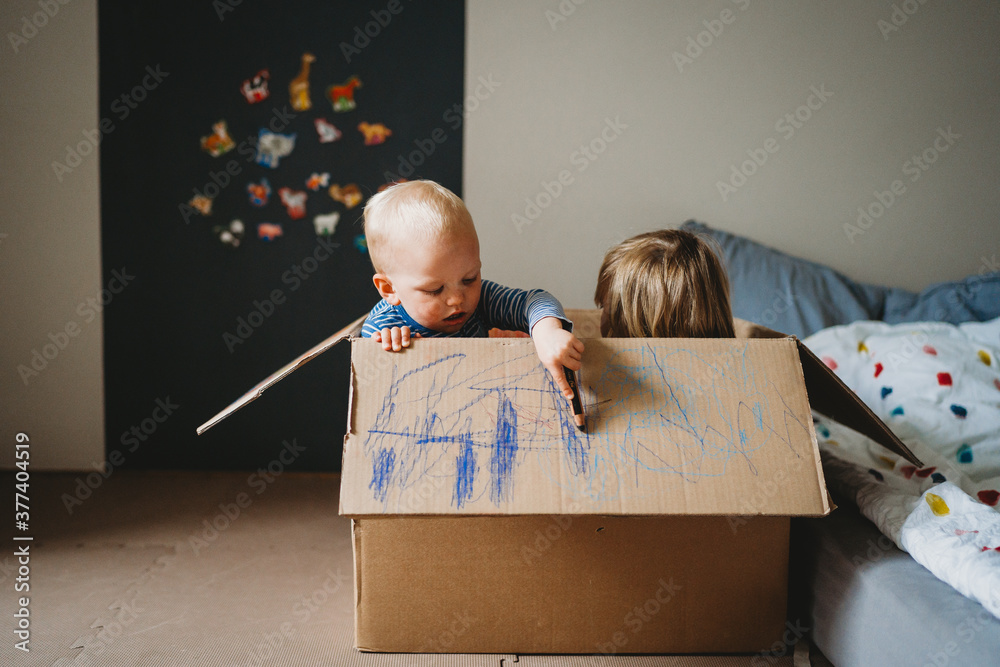Kids playing and drawing in a box during lockdown Stock Photo | Adobe Stock