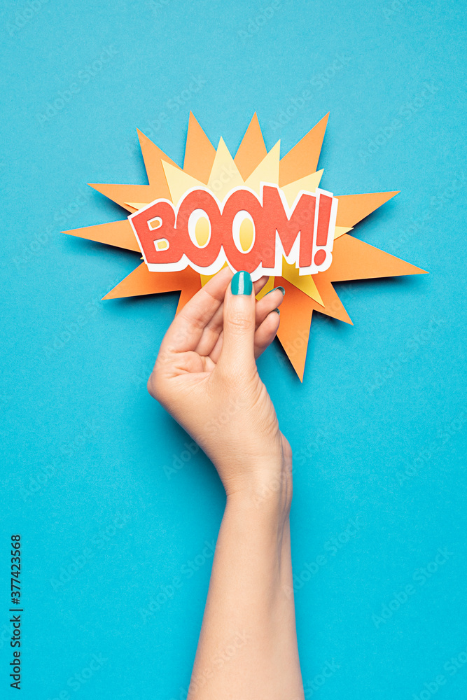 Hand holding a ""boom"" letters Stock Photo | Adobe Stock
