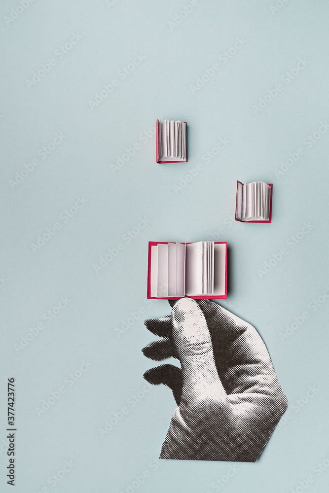 Hand holding a book Stock Photo | Adobe Stock