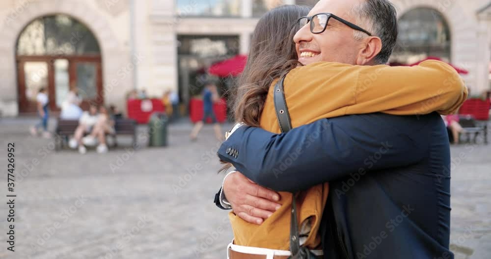 Handsome middle-aged Caucasian father meeting adult happy daughter in ...