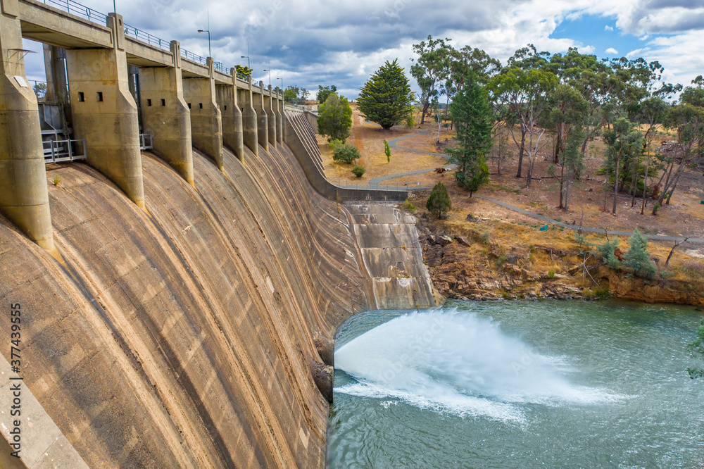 Looking down on a jet of water squirting from the bottom of a dam wall ...