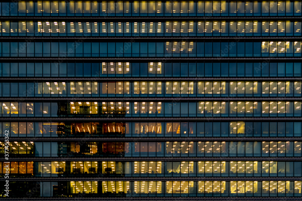 wall background of tower glass exterior facade with interior yellow ...