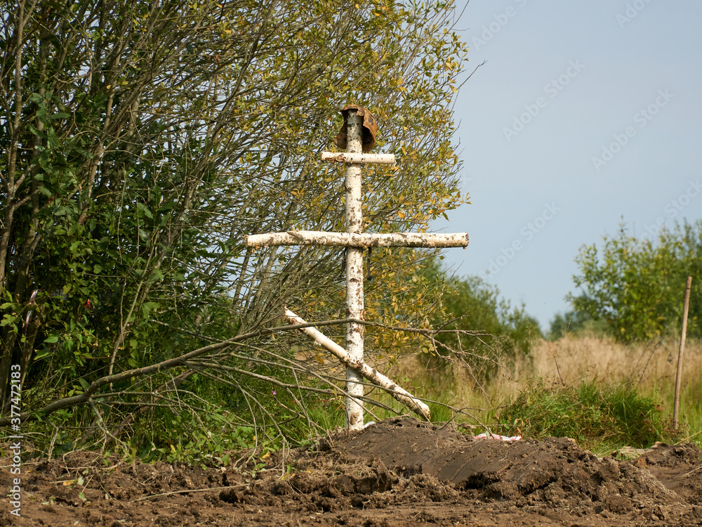 A birch cross at the site of a mass grave of Soviet soldiers during the ...