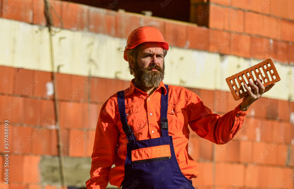 brickwork. Man takes brick from the pile. Male construction worker ...