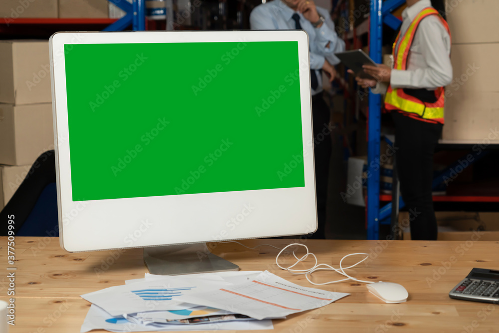Computer with green screen display in warehouse storage room . Delivery ...