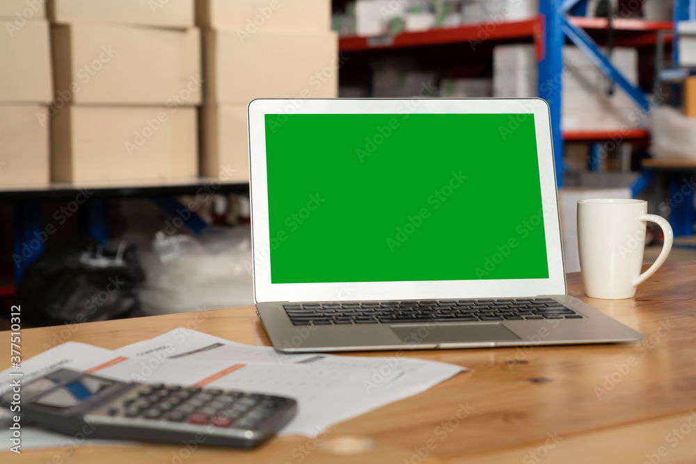 Computer with green screen display in warehouse storage room . Delivery ...