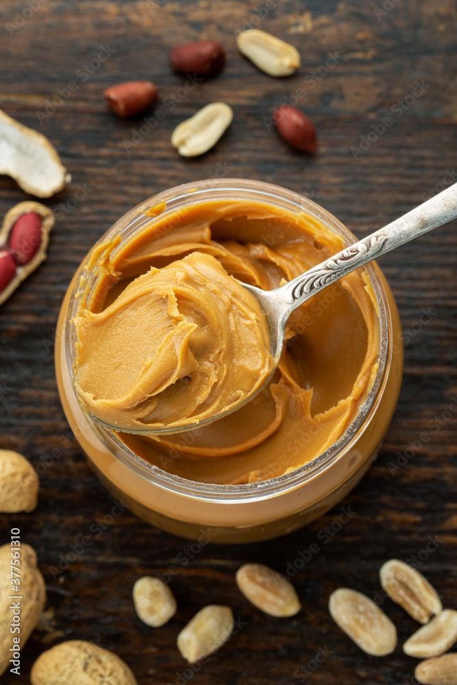peanut paste in an open jar and peanuts in the peel Stock Photo | Adobe ...