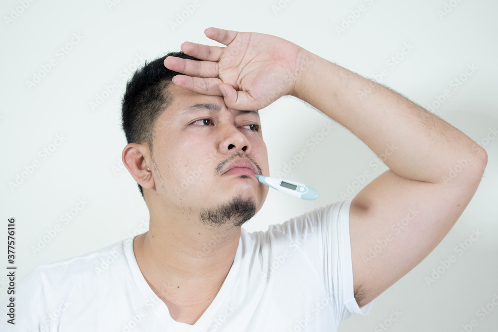 people, healthcare and fever concept - unhealthy asian man measuring ...