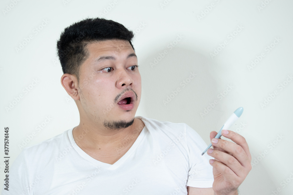 People Healthcare And Fever Concept Unhealthy Asian Man Measuring
