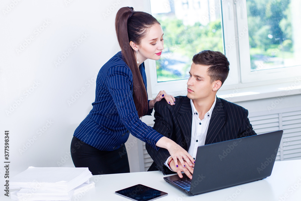 Sexual harassment at work. A businesswoman harasses a young colleague ...