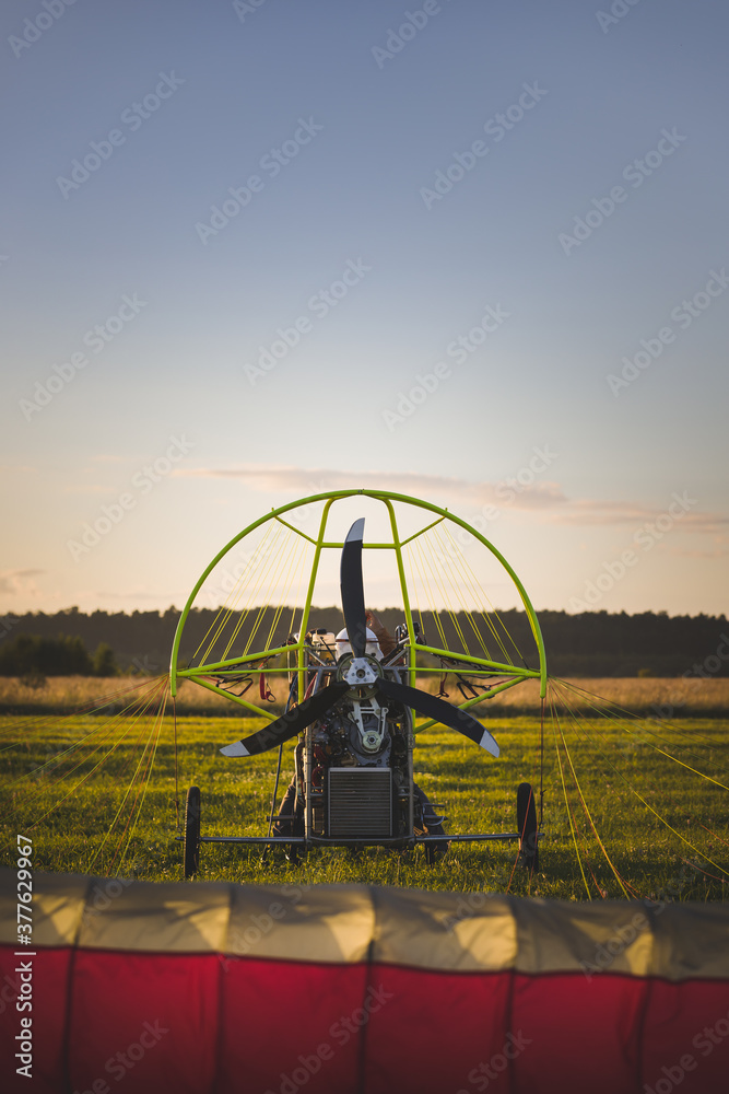 Rear view of a motorized paragliding trolley with a gasoline engine for ...