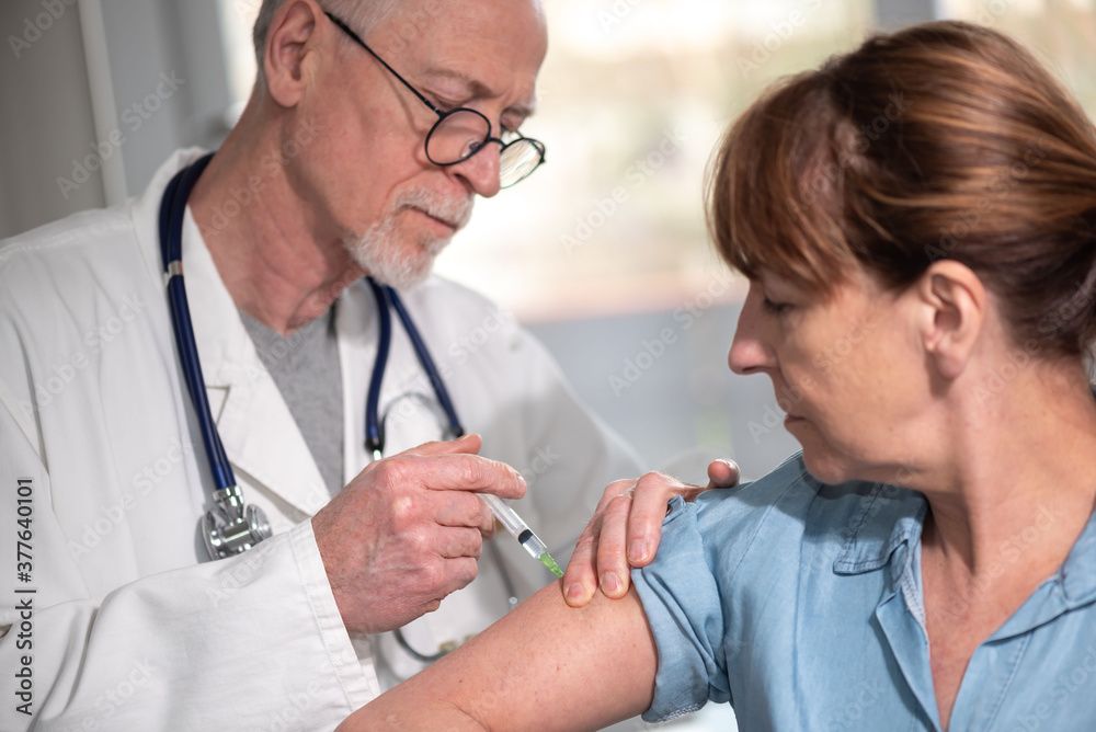 Doctor giving vaccin injection to patient Stock Photo | Adobe Stock
