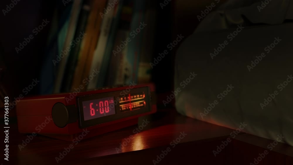 Vintage alarm clock with digital dial and radio waking up at 6 AM ...
