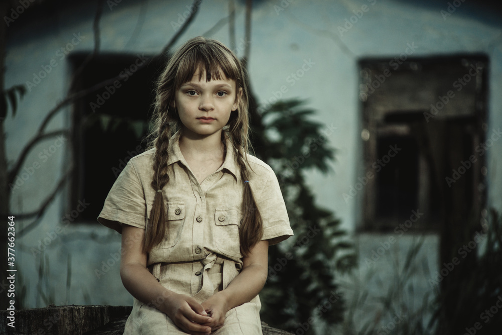 sad teenage girl sitting by an abandoned building Stock Photo | Adobe Stock