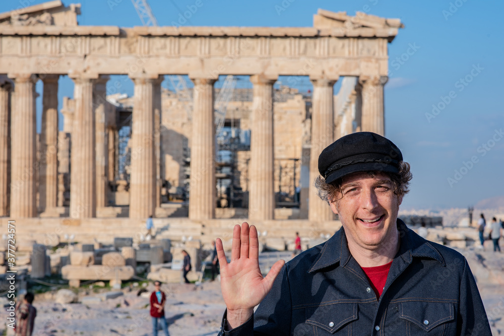 Portrait of a father waving to the camera in front of the ancient ...