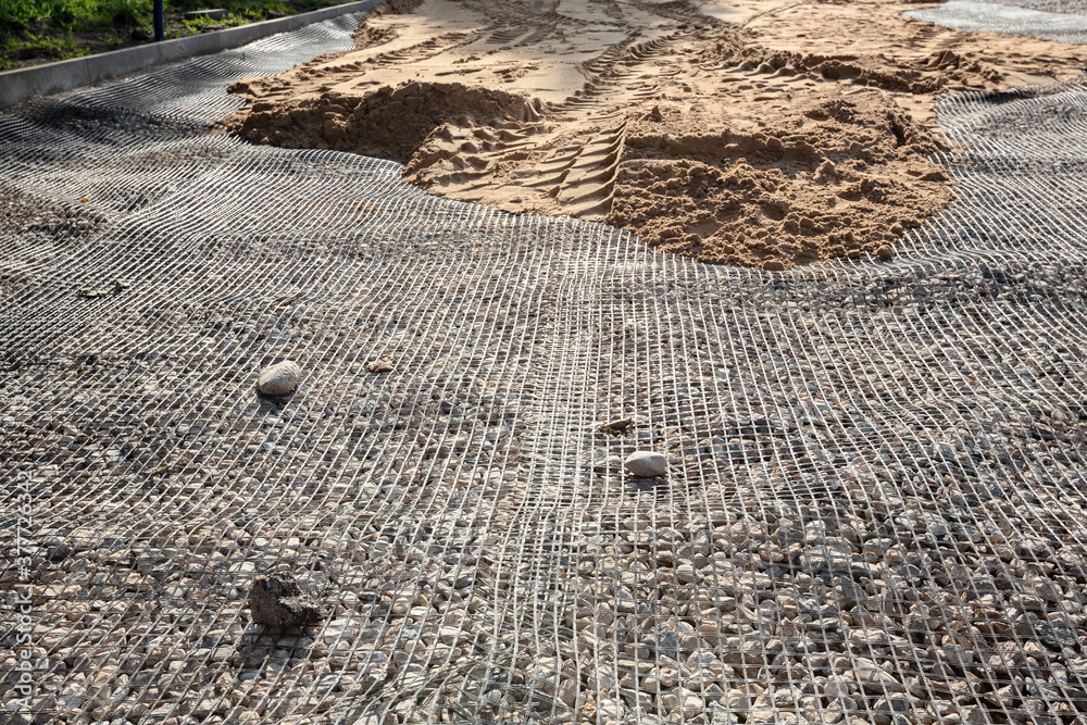Stage of road surface construction. Aligns the sand layer over the ...