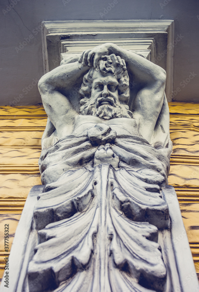 Ancient statue of Atlant. Sculpture of a male body in the architecture ...