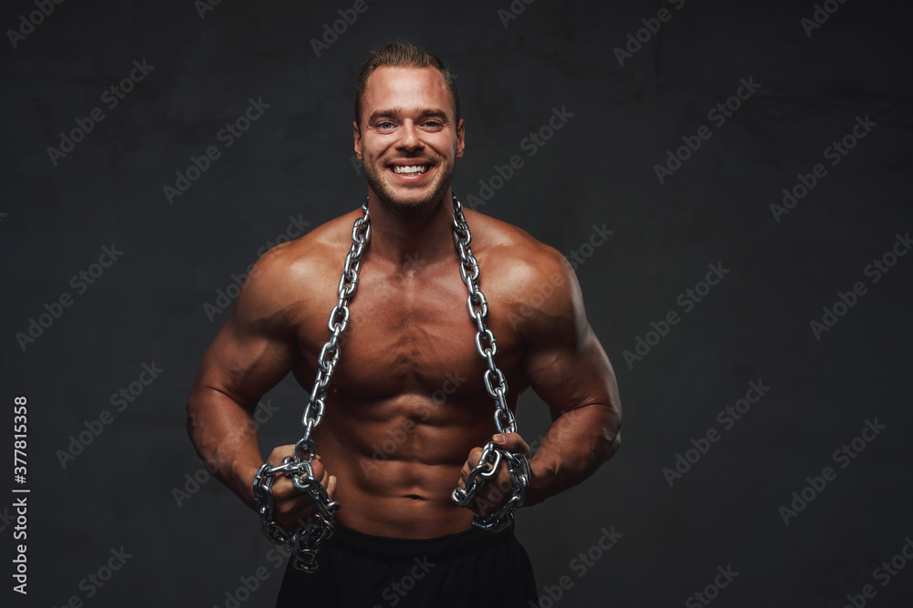 Succesful sportsman shows his body and results of trainings and posing ...
