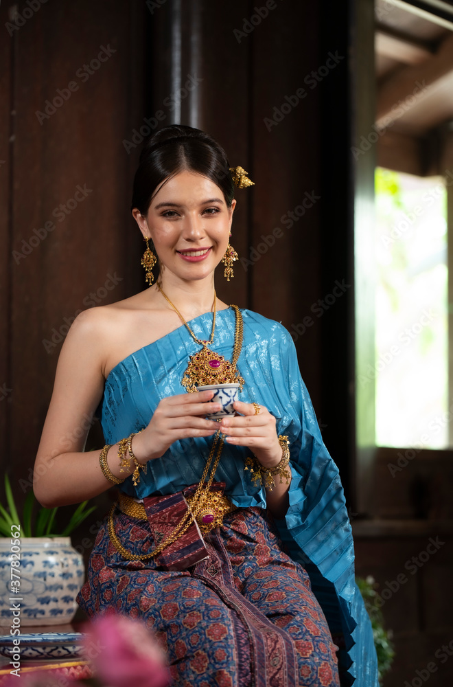 Portrait of a beautiful woman in Thai old suit or Thai national dress ...