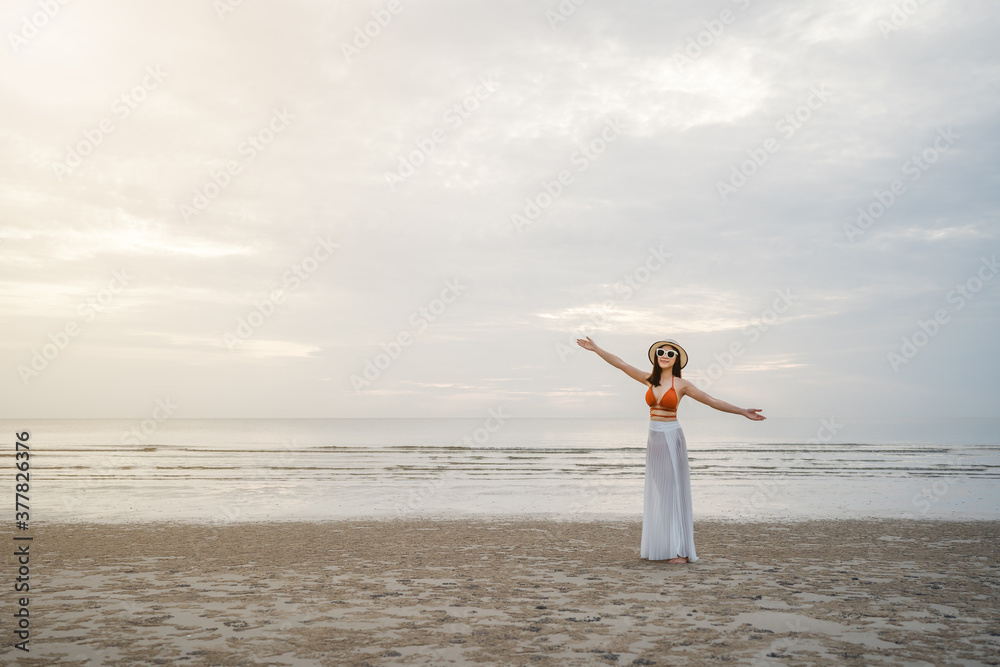 freedom woman in bikini walking with arms raised on sea beach Stock ...