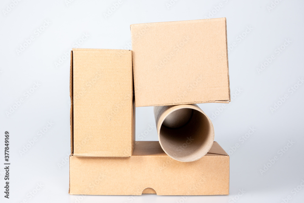 Stack of cardboard boxes with card board tube on white background Stock ...