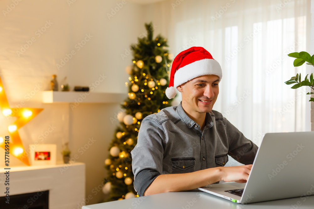 man in santa claus hat holding laptop with merry christmas typing Stock ...