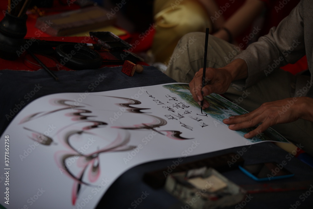 Hanoi, Vietnam - Calligrapher writing words on paper. Calligraphy is ...
