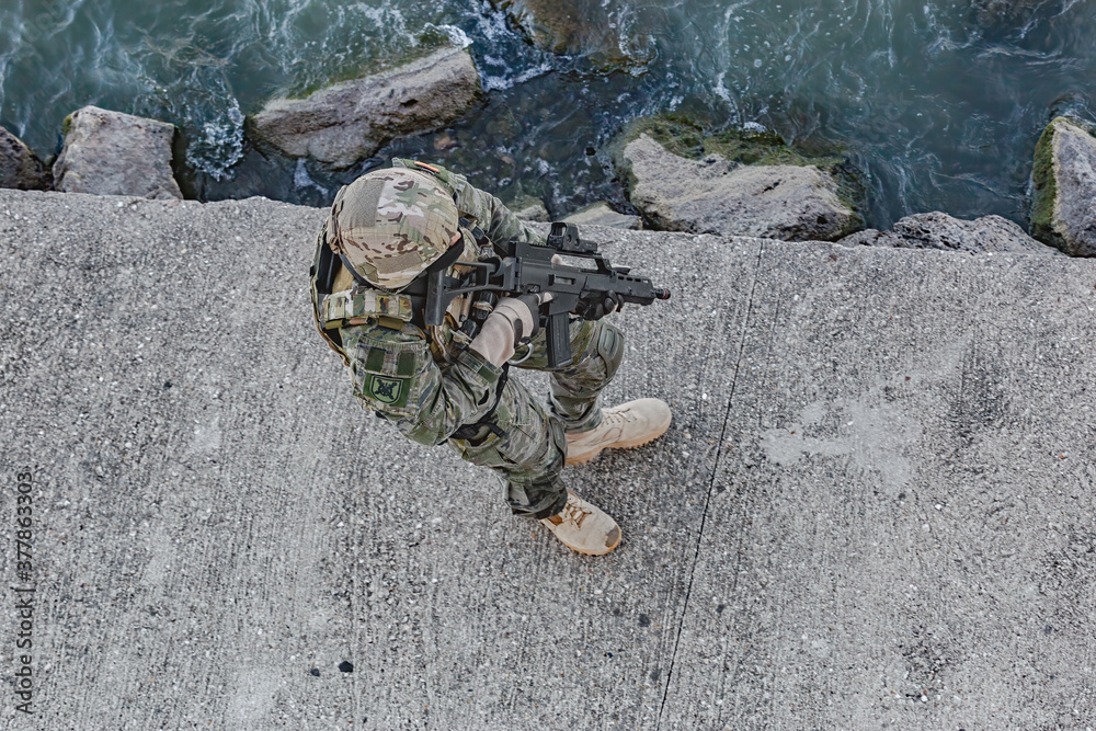 Army soldier in Combat Uniforms with assault rifle. Military equipment ...
