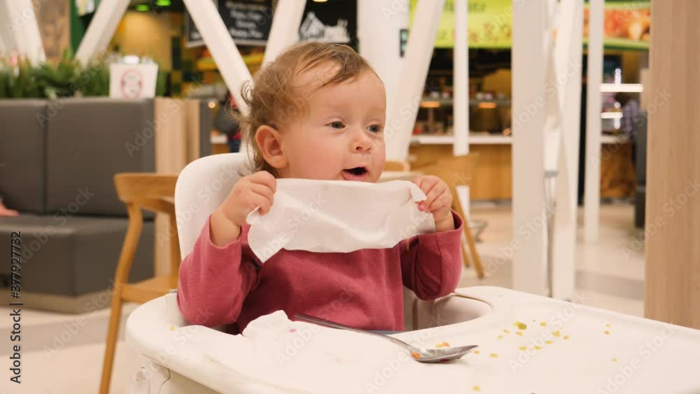 Cute funny little baby child girl after eating in mall food court try ...