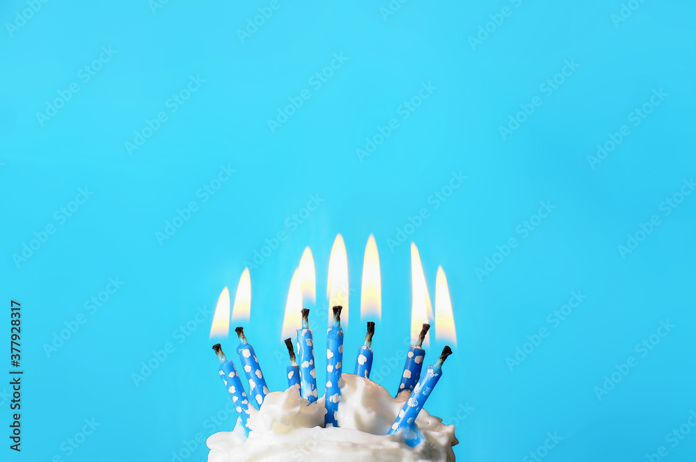 cream cake with blue candles on top, the candles have white dots and ...