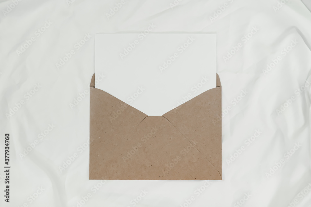 Blank white paper is placed on the open brown paper envelope on white ...