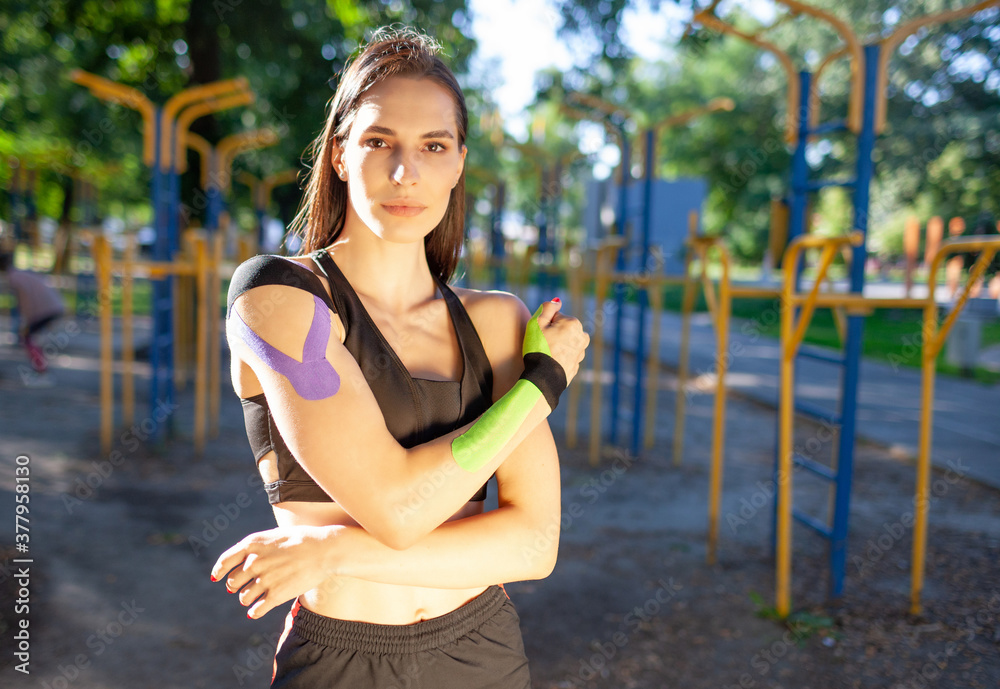 Portrait of attractive muscular brunette woman wearing black sports ...