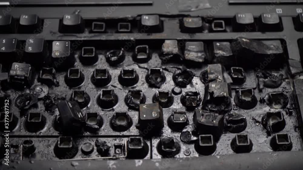 Broken keyboard on the computer desk. The angry man smashed the ...
