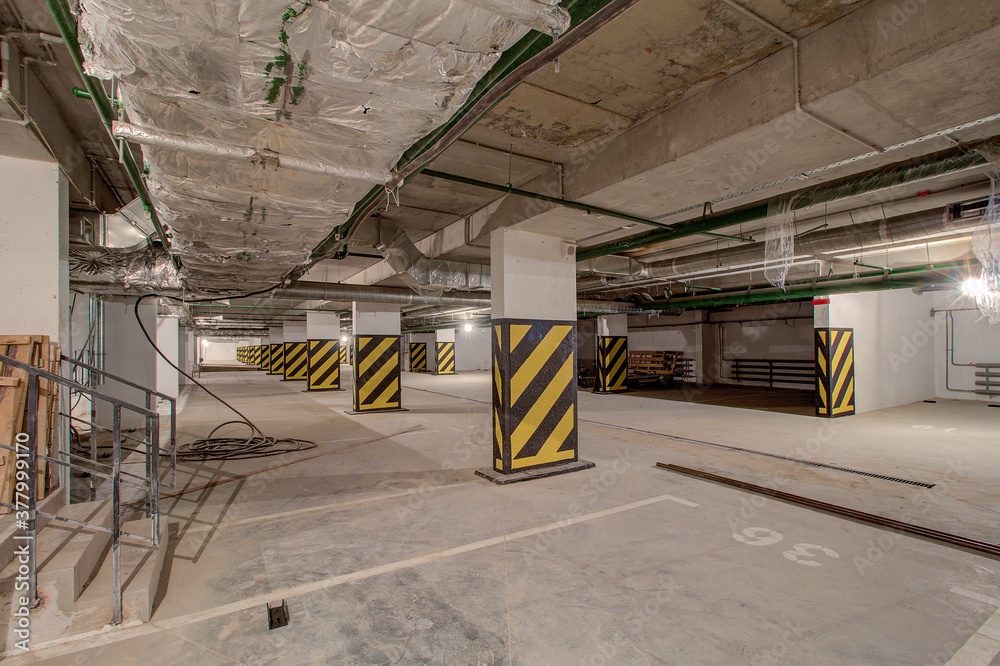 Underground parking in construction phase. Empty garage in basement of ...