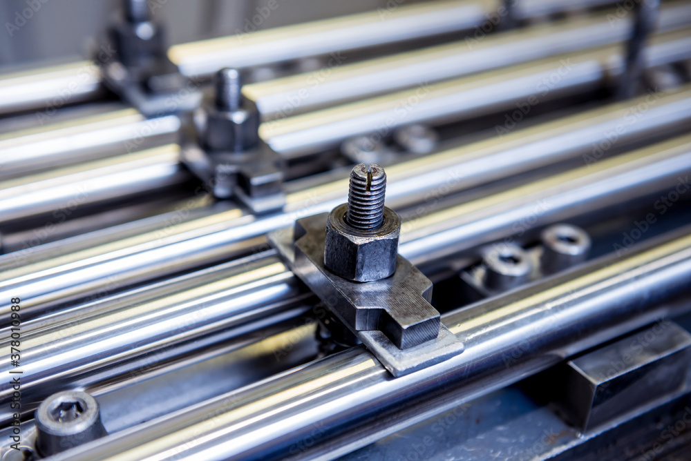 CNC milling machine drills holes in the pipe. Stock Photo | Adobe Stock
